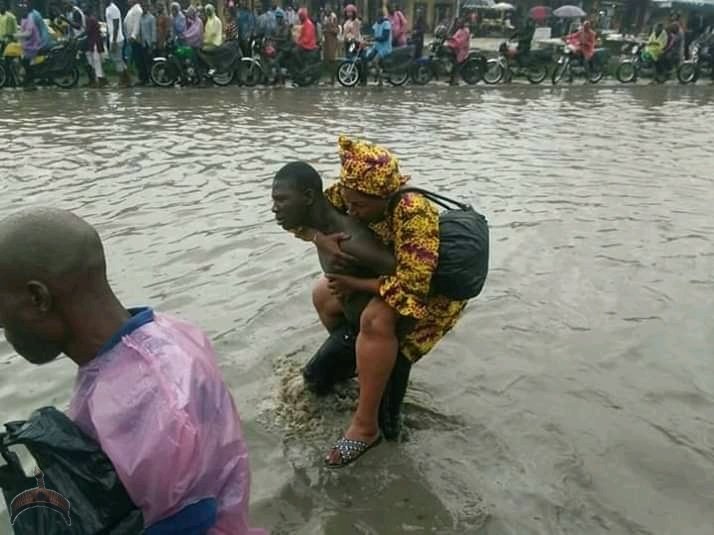 Aboki Pictured Making Money by Carrying People Across Flood In Badagry ...